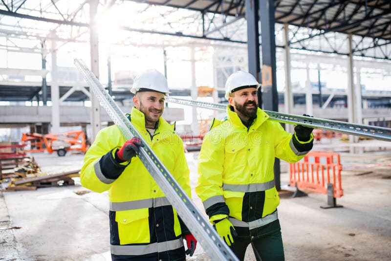 Men Workers Walking Outdoors on Construction Site, Working. Stock Image ...