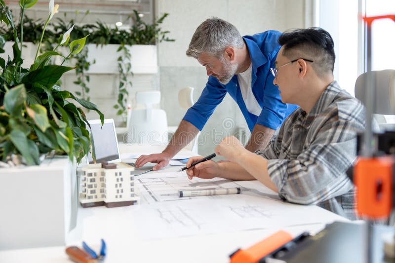 Men Working with 3D Printer and Blueprint for Designing Mechanical ...