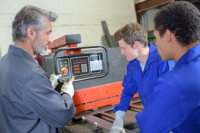 3 men working with machine stock photo. Image of teen - 161830064