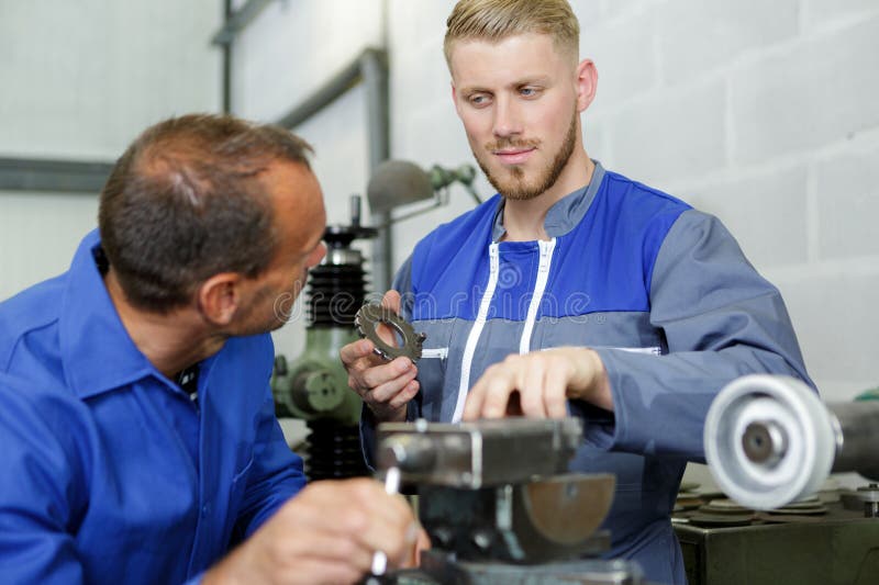 Men working on metal piece stock photo. Image of manual - 273524538