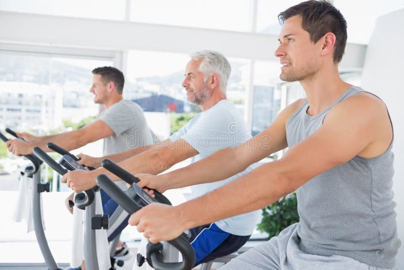 Men Working Out on Exercise Machines Stock Image - Image of mature ...