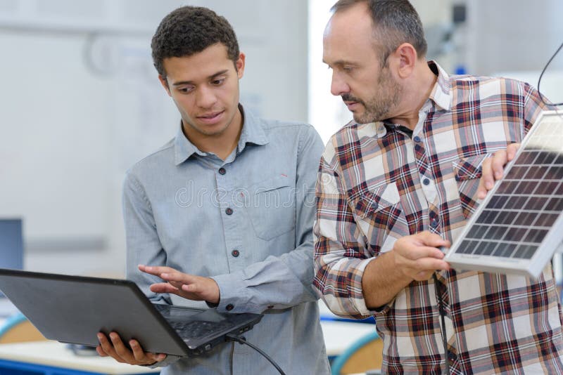 Men in Workshop with Laptop and Solar Panel Stock Photo - Image of ...