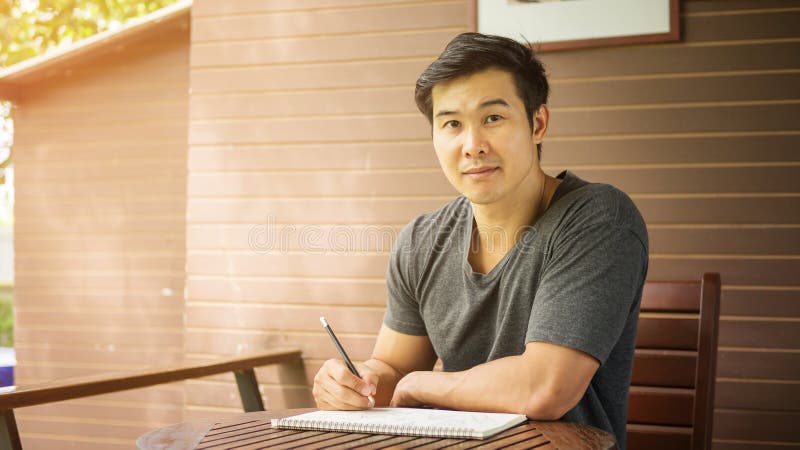 Men Writing a Book on a Balcony Stock Photo - Image of asian, morning ...