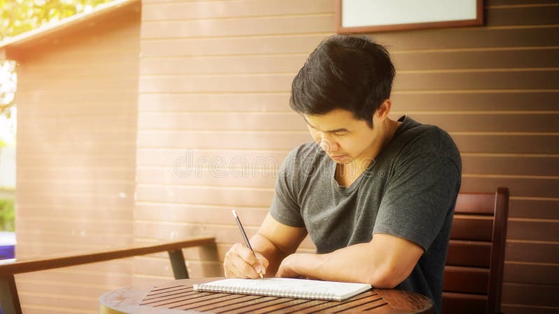 Men Writing a Book on a Balcony Stock Photo - Image of casual, book ...