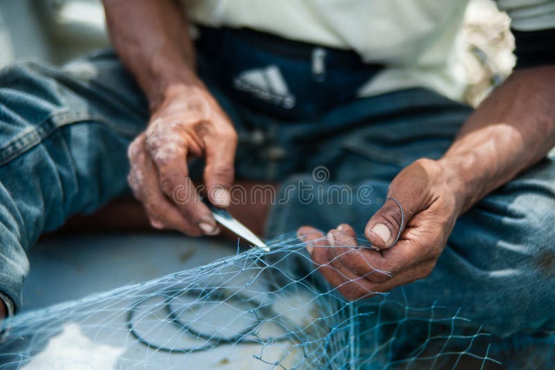 Fisherman Mending Nets stock image. Image of darns, fixes - 35579615