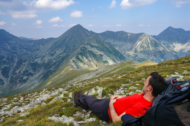 Man Die Op Het Gras Op De Berg Ligt Stock Afbeelding - Image of ...