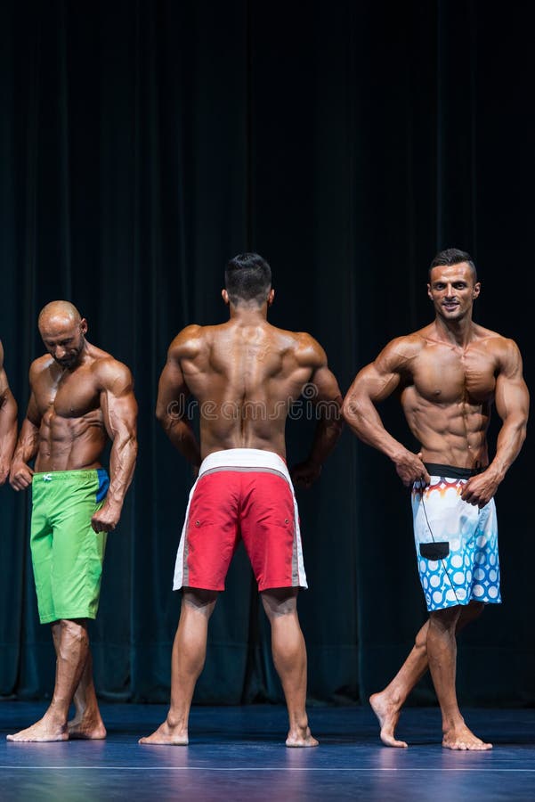 Mens Physique Posing during a Bodybuilding Competition Stock Photo ...