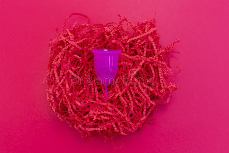 Menstrual Cup in Red Shredded Paper Packaging Material Flat Lay on Red ...