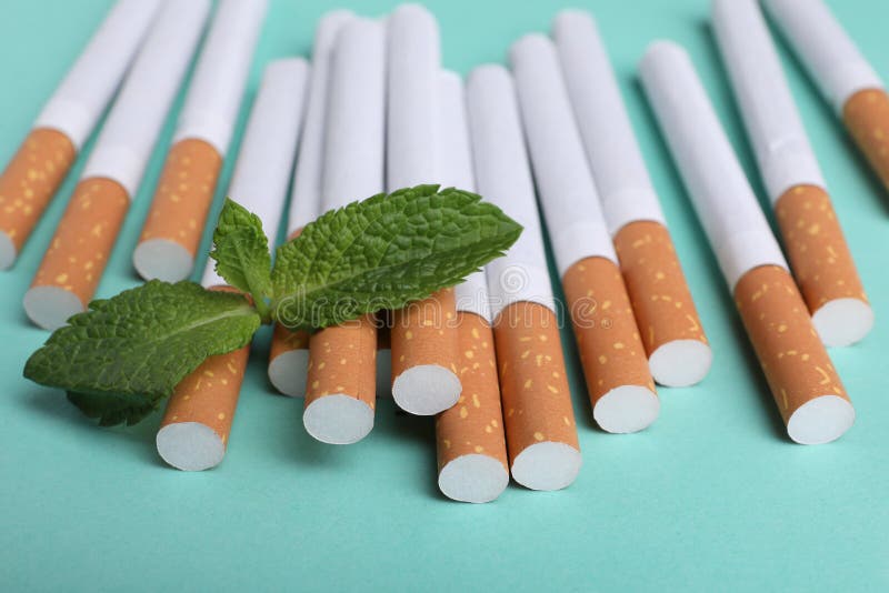 Menthol Cigarettes and Mint on Turquoise Background, Closeup Stock ...