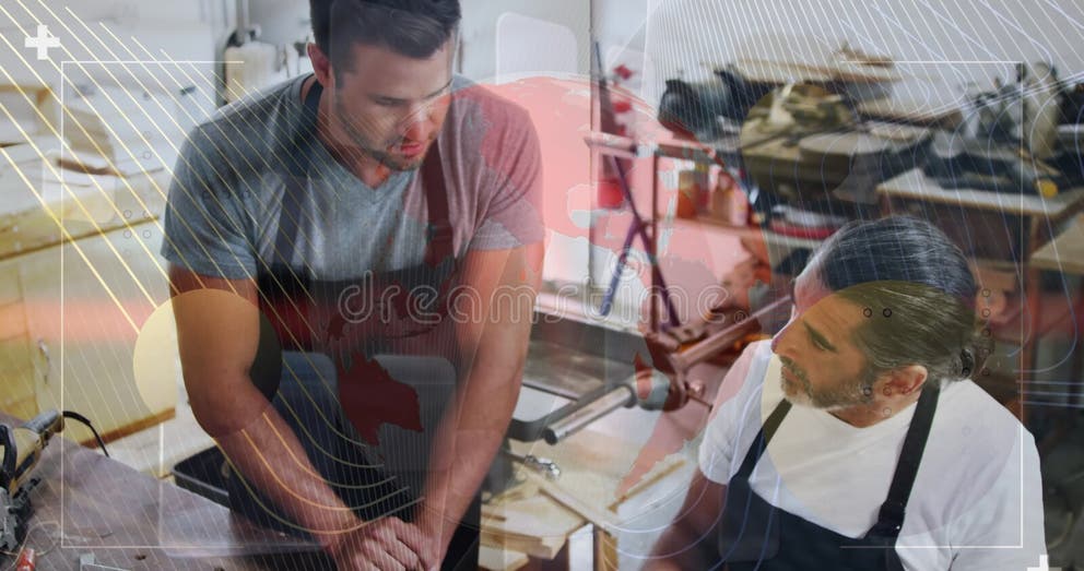 Mentor and Apprentice Practicing Joinery at Workbench in Workshop, with Drill Press and Shavings ...