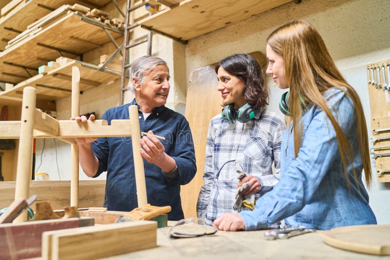 Mentor Guiding Apprentices in Woodworking at a Busy Lumberyard Stock Image - Image of learning ...