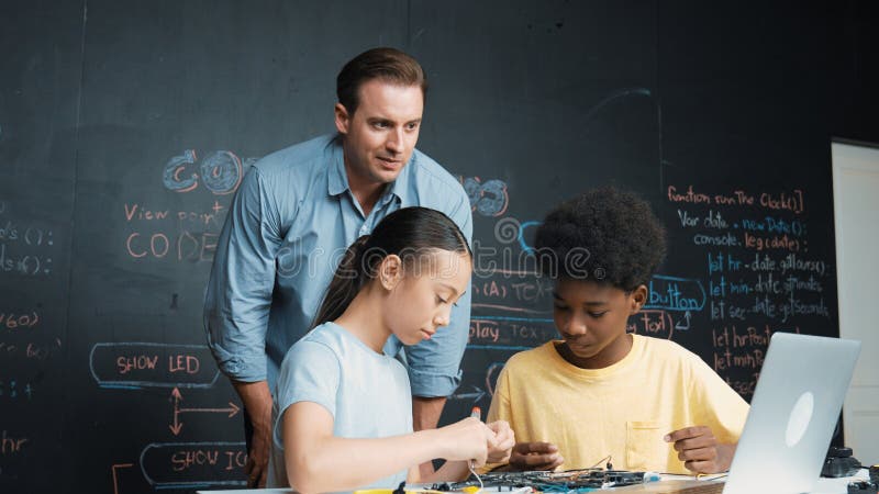 Mentor Talk about Electric Tool while Student Fixing Robotic Model ...