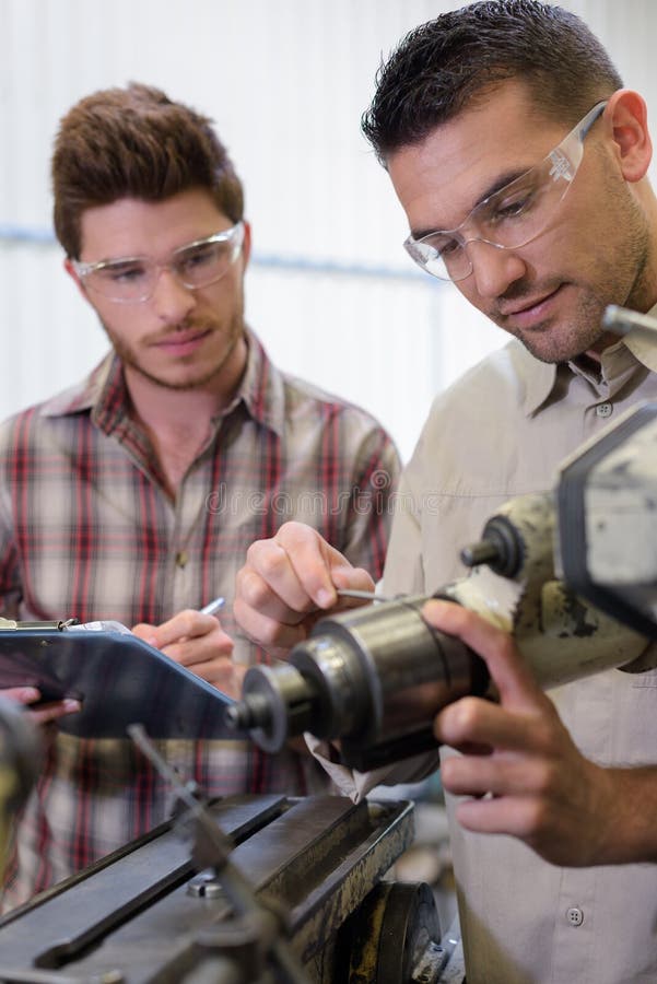 Mentor and Young Apprentice Adjusting Piece Metal Stock Photo - Image ...