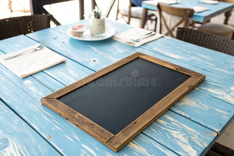 "Menu Blackboard Frame on Blue Wooden Dining Table - Rustic Dining ...