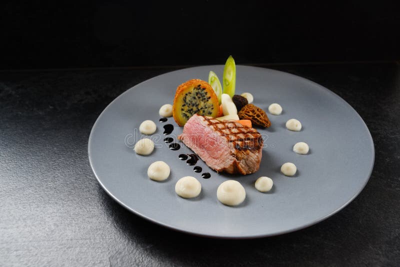 Menu Main Course with Roasted Veal, Morels and Vegetables on a Blue ...