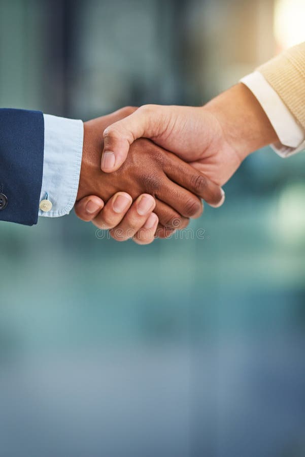The Merging of Two Business Greats. Two Businessmen Shaking Hands in a ...