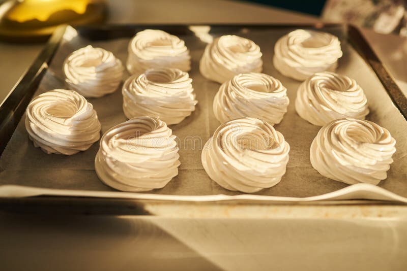 Meringue on a baking sheet stock image. Image of home - 198528405