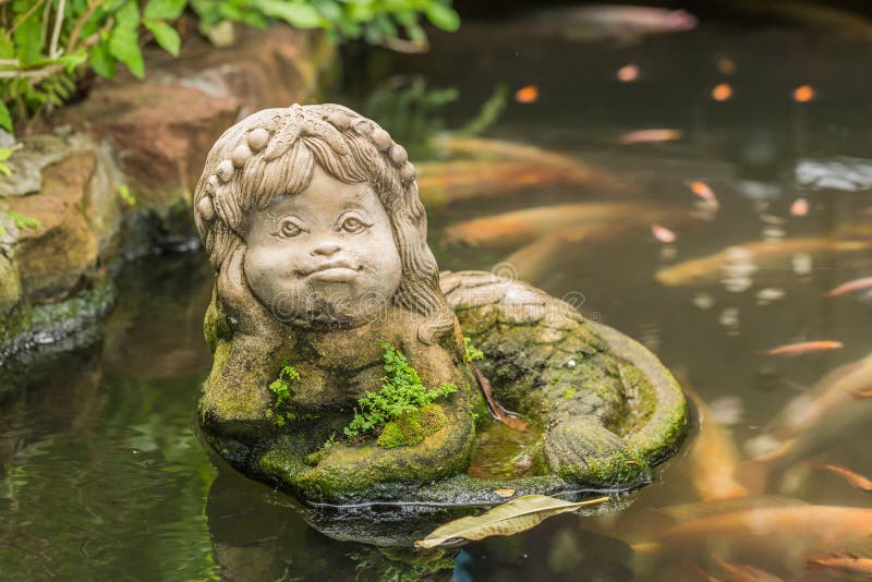 Mermaid statue in the pond stock image. Image of statue - 64064973
