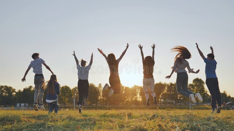 Merry Friends Jumping Around at Sunset. Stock Image - Image of group ...