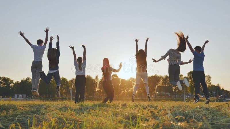 Merry Friends Jumping Around at Sunset. Stock Image - Image of teen ...