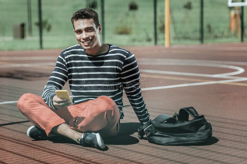 Merry Positive Guy Exchanging Messages on Ground Stock Photo - Image of ...