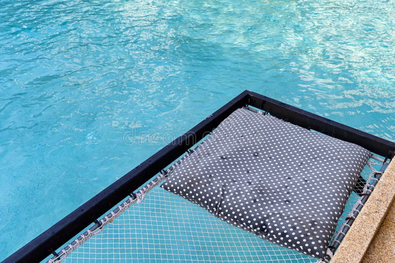 Mesh Seat with Pillows Jut Out on Swimming Pool Stock Photo - Image of ...