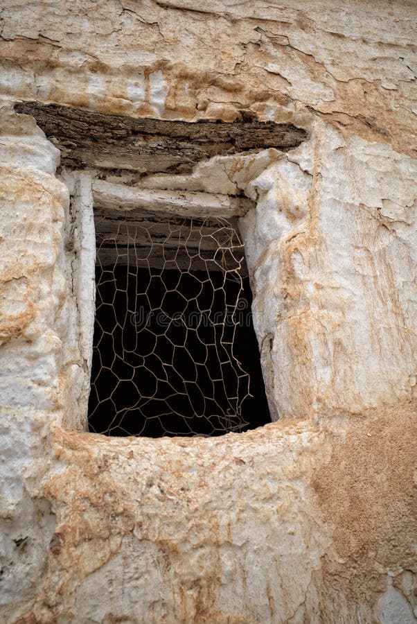 Wire Mesh Window Covering Opening in Dust Covered Building. Calima or ...