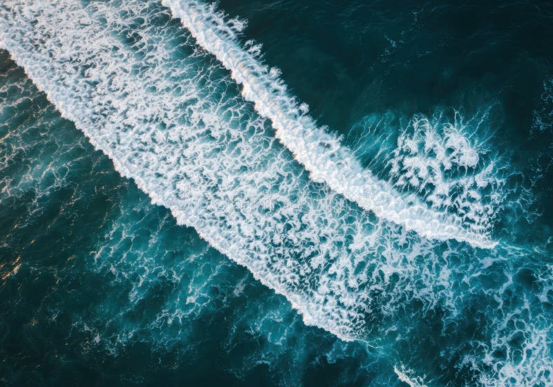 A Mesmerizing Aerial View of Ocean Waves Creates a Beautiful Foamy ...