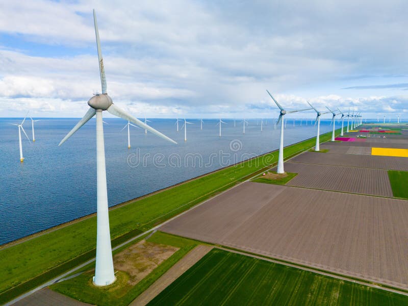 A Mesmerizing Aerial View of a Wind Farm Near the Ocean, Where Giant ... A Mesmerizing Aerial View of a Wind Farm Near the Ocean, Where Giant ...