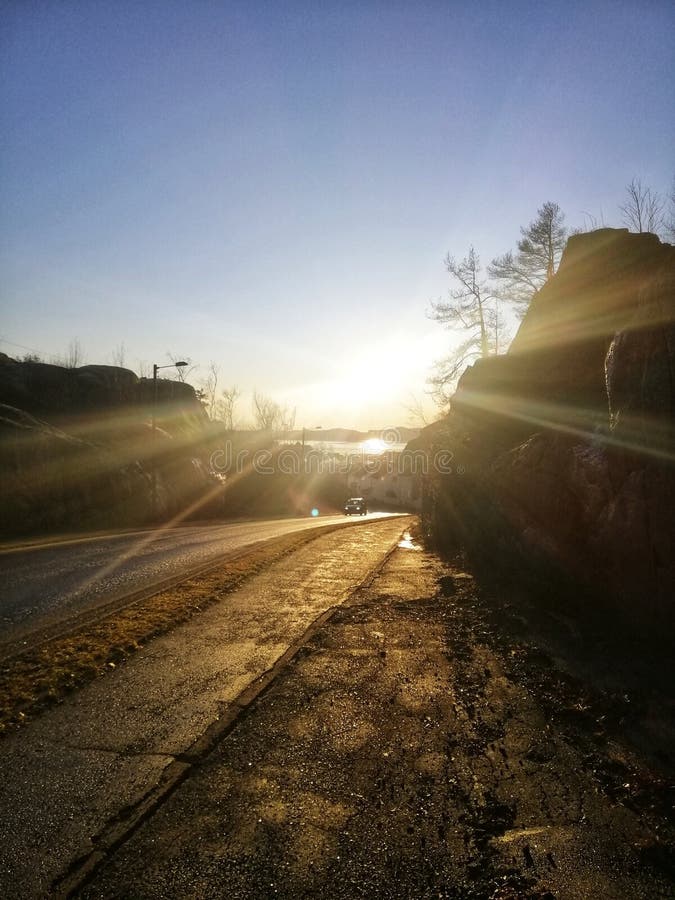 Mesmerizing Bright Sunrise Over the Road Surrounded by Rock Formations ...