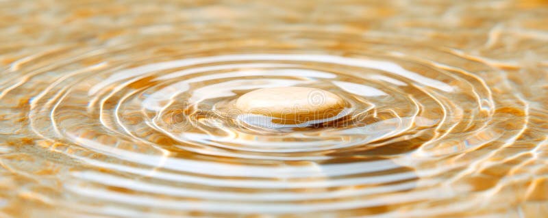 Mesmerizing Concentric Ripples Spreading Across a Golden Water Surface ...