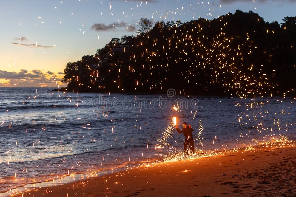 A Dynamic Fire Performerat the Beach during the Beautiful Sunset. Stock ...