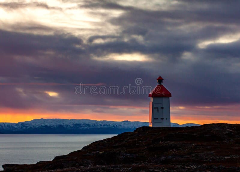 Mesmerizing Landscape of a Lighthouse on the Rocky Shore at Soft Sunset ...