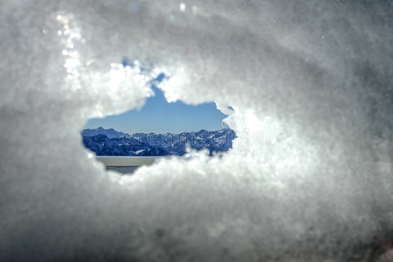 Mesmerizing Scene of a Mountain Range through a Snow Hole Stock Image ...