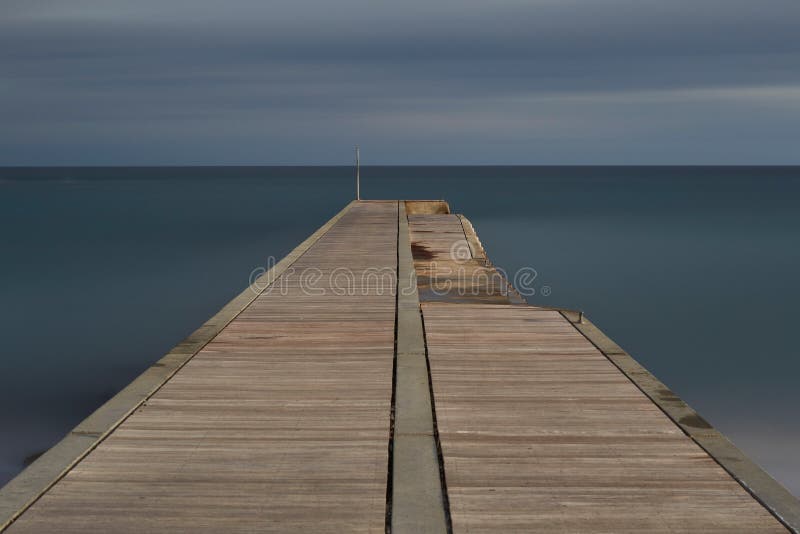 Mesmerizing Scenery of a Pier Leading To the Frozen Ocean Stock Image ...