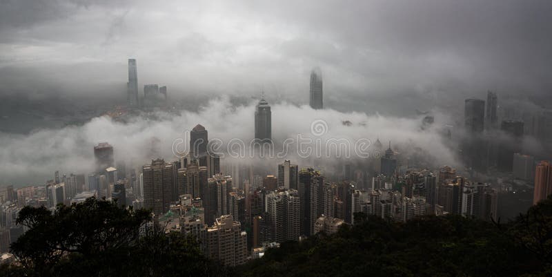 Mesmerizing Shot of the Skyscrapers of a City Covered in Mist at Night ...
