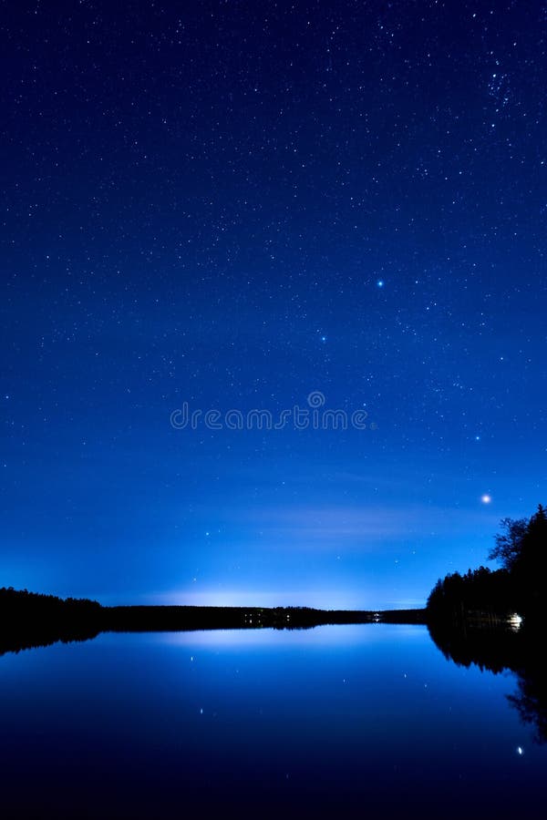 Mesmerizing Starry Night Sky Over a Pond Reflecting on the Water ...