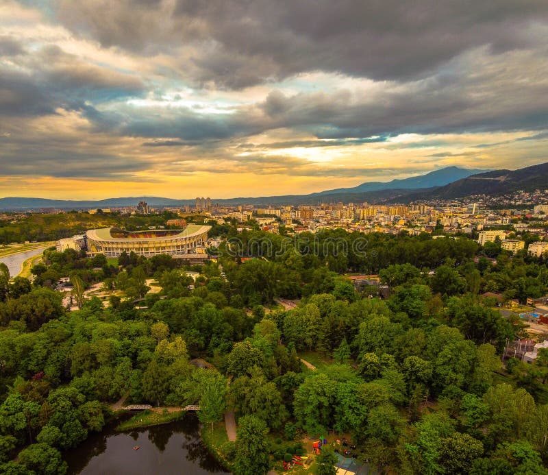 Mesmerizing Sunset Over the City with Green Trees Stock Photo - Image ...