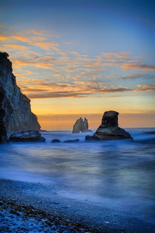 Mesmerizing Sunset Scenery Over the Sea with Huge Rocky Cliffs Stock ...