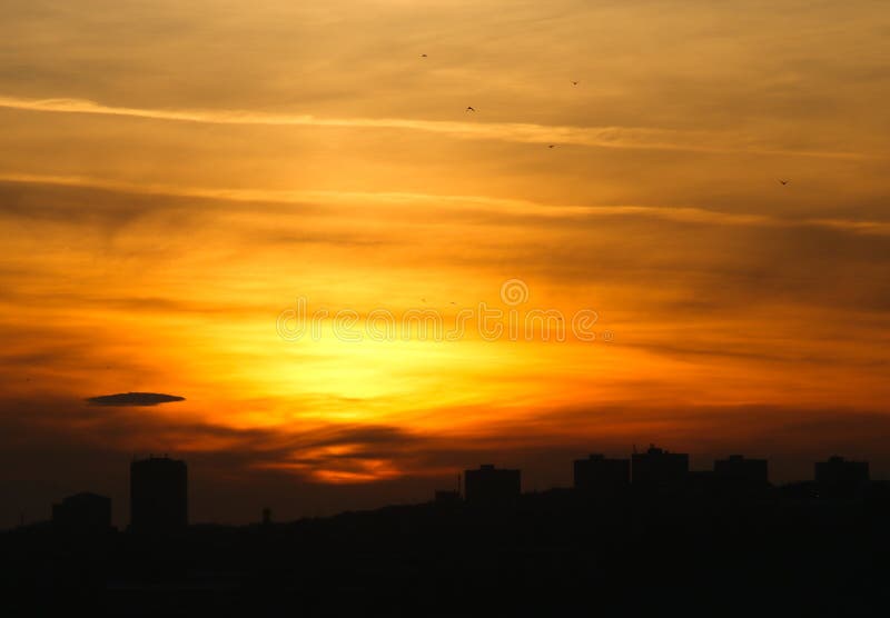 Mesmerizing Sunset Sky Over the Silhouettes of Buildings Stock Photo ...