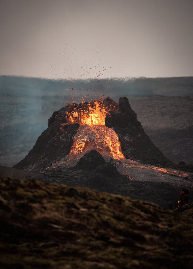 Mesmerizing Vertical Shot of an Active Volcano with Flowing Lava and ...