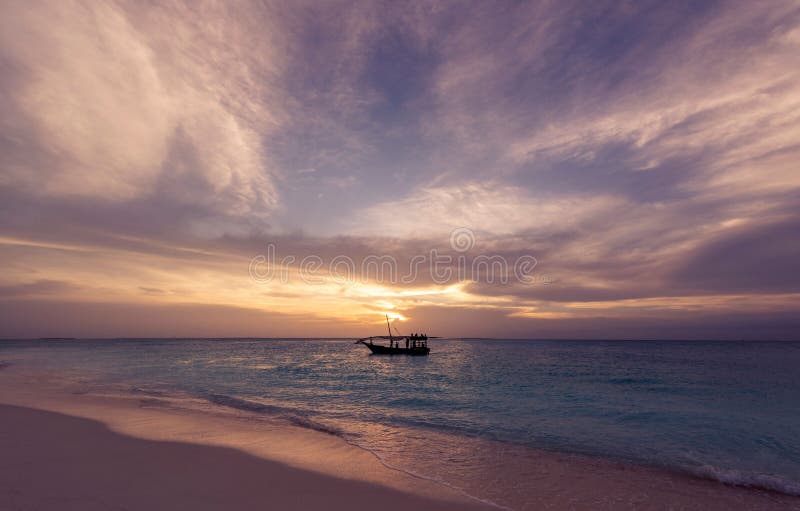 Mesmerizing View of a Boat on the Beach at Sunset Stock Photo - Image ...