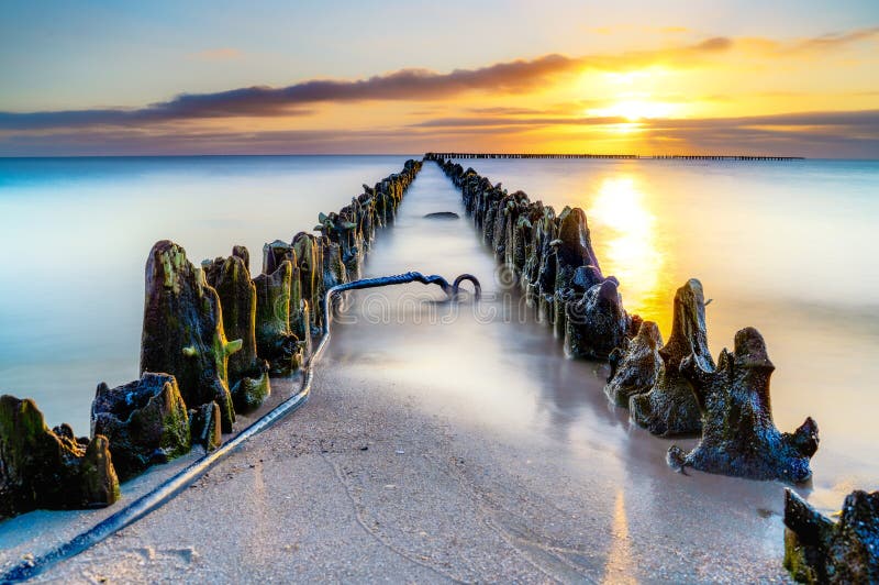 Mesmerizing View of the Breakwaters in the Sea during Sunset Stock ...