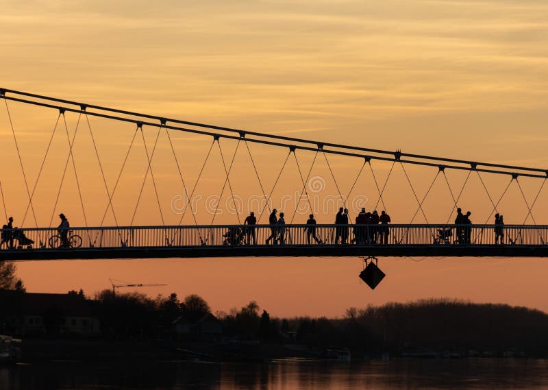 Mesmerizing View of the Bridge Over the River and the Silhouettes of ...
