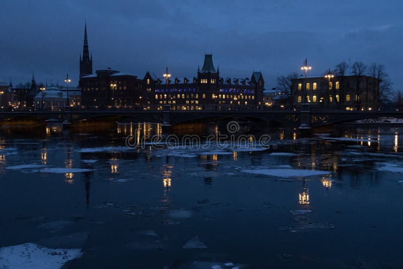 Mesmerizing View of the Building Behind the Bridge Over the Frozen Lake ...