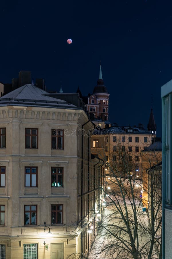 Mesmerizing View of the Buildings and the Full Moon at Night Stock ... Mesmerizing View of the Buildings and the Full Moon at Night Stock ...