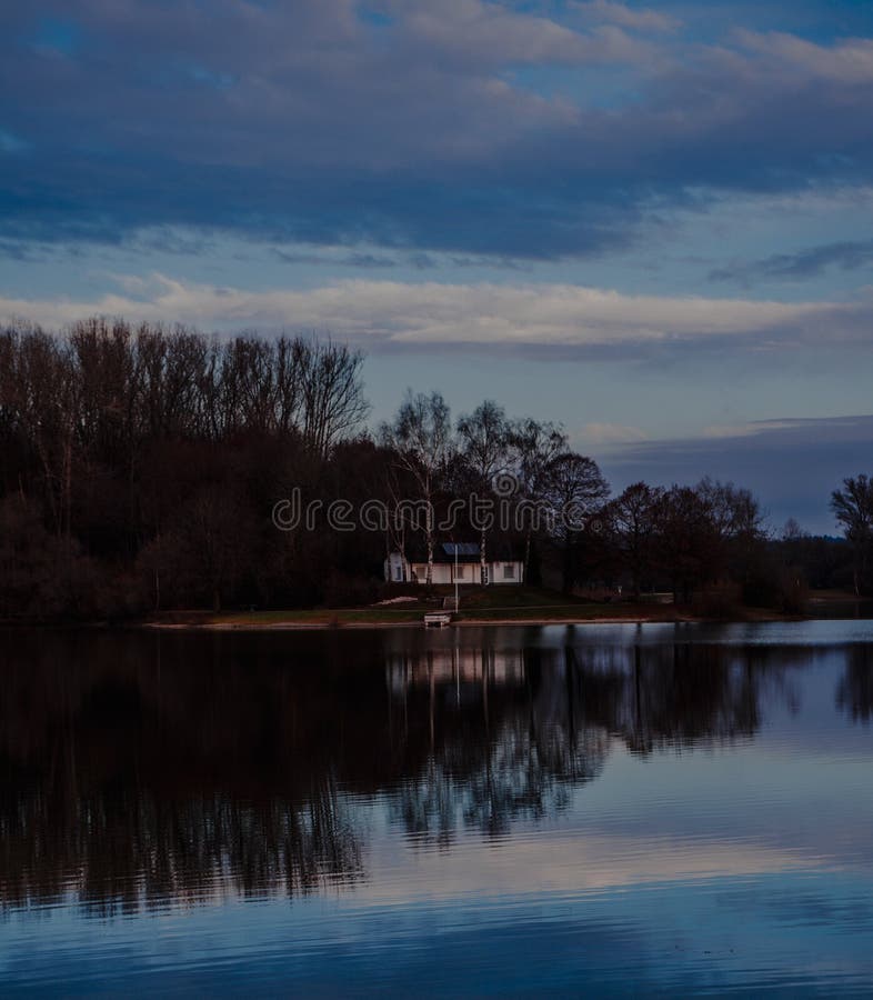 Mesmerizing View of the Cloudy Sky Reflecting on the Lake Surrounded by ...