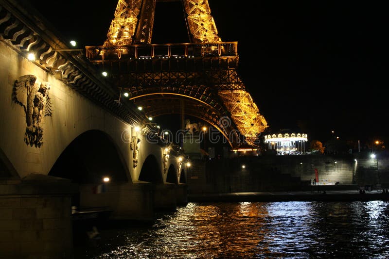 Mesmerizing View of the Eiffel Tower at Night Near the Bridge Over a ...