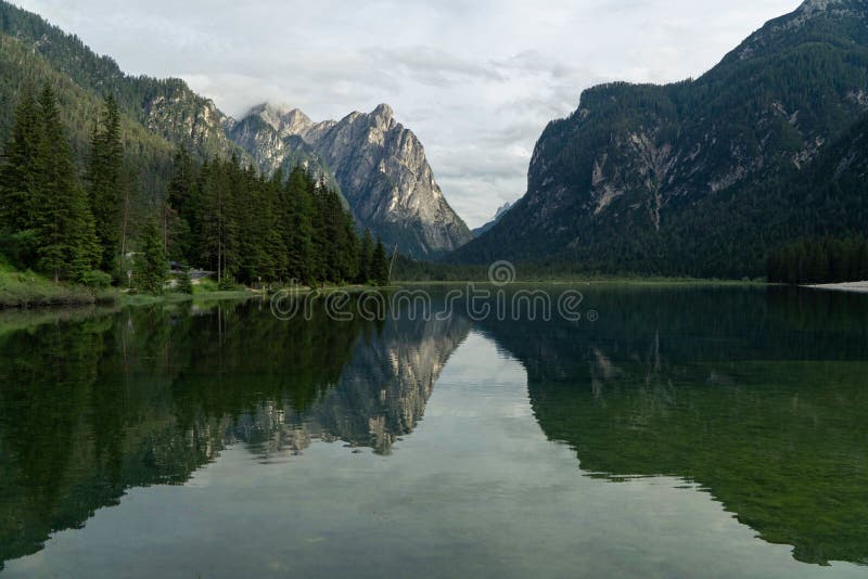 Mesmerizing View of Mountains and Trees Reflected in Lake Dobbiaco in ...