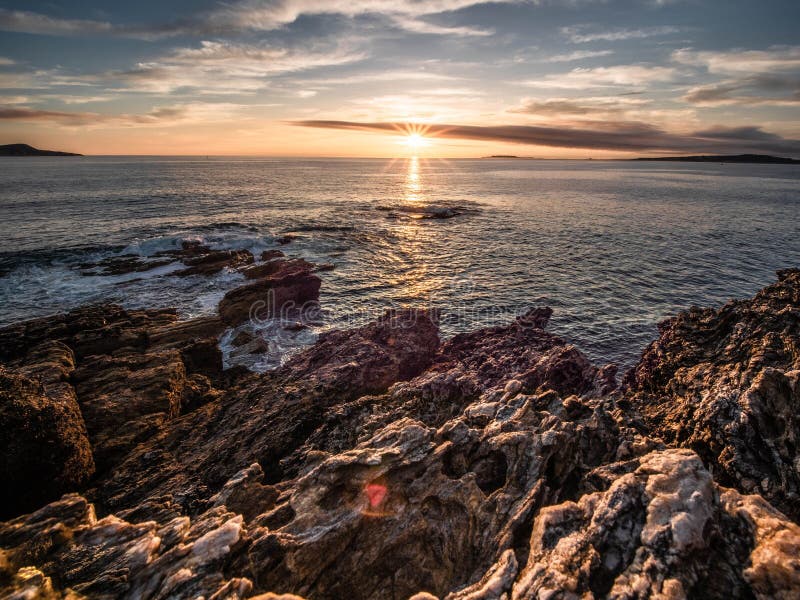 Mesmerizing View of the Ocean Captured from the Rocky Coast at Sunset ...